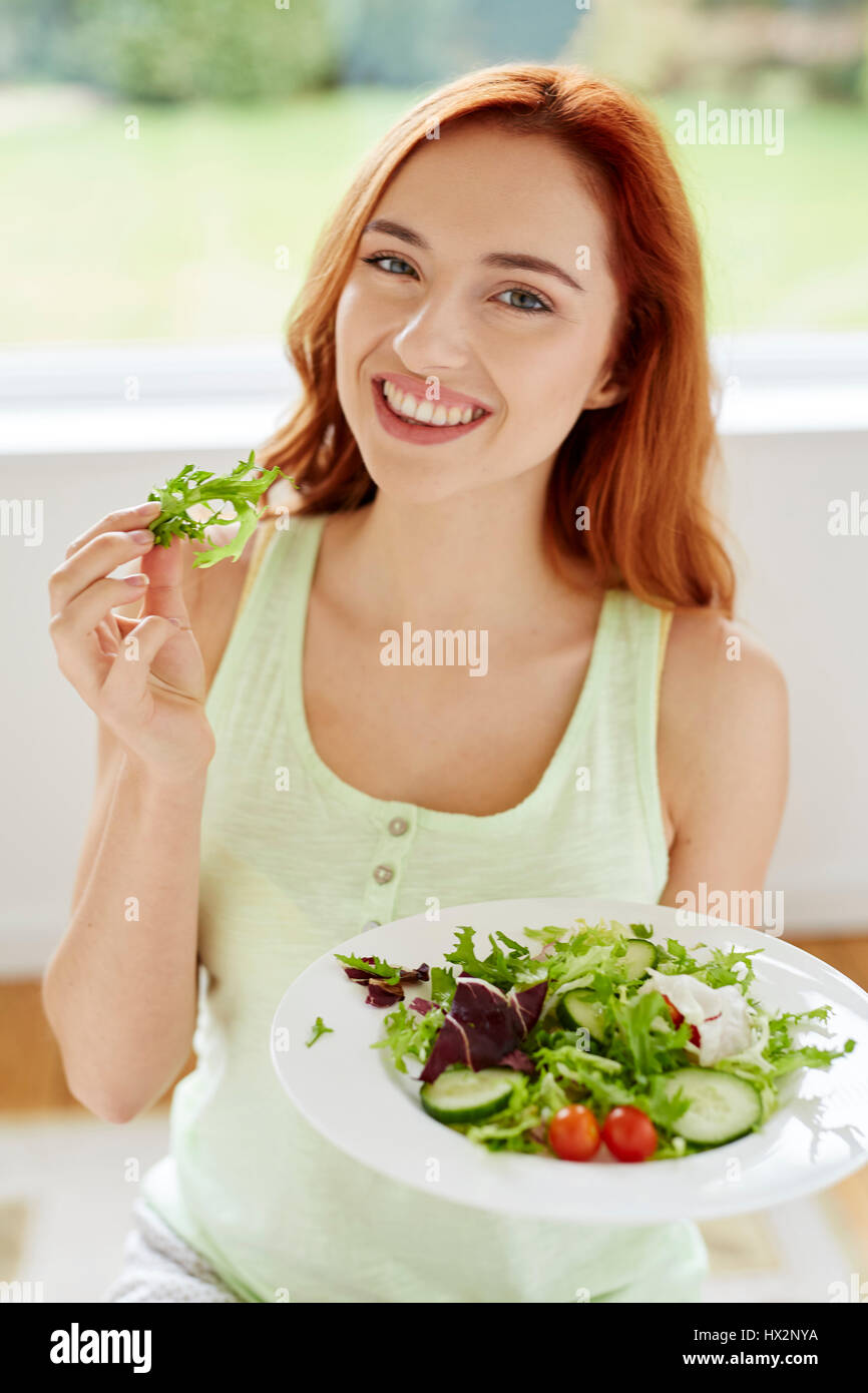 Girl eating healthy salad Stock Photo - Alamy