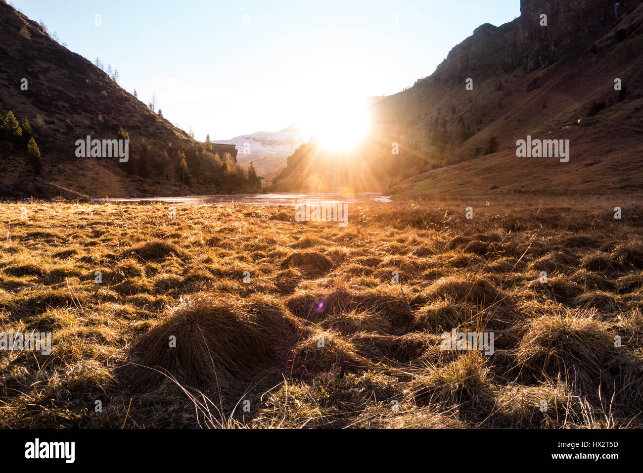 Sunset in a valley between mountains with small river Stock Photo - Alamy