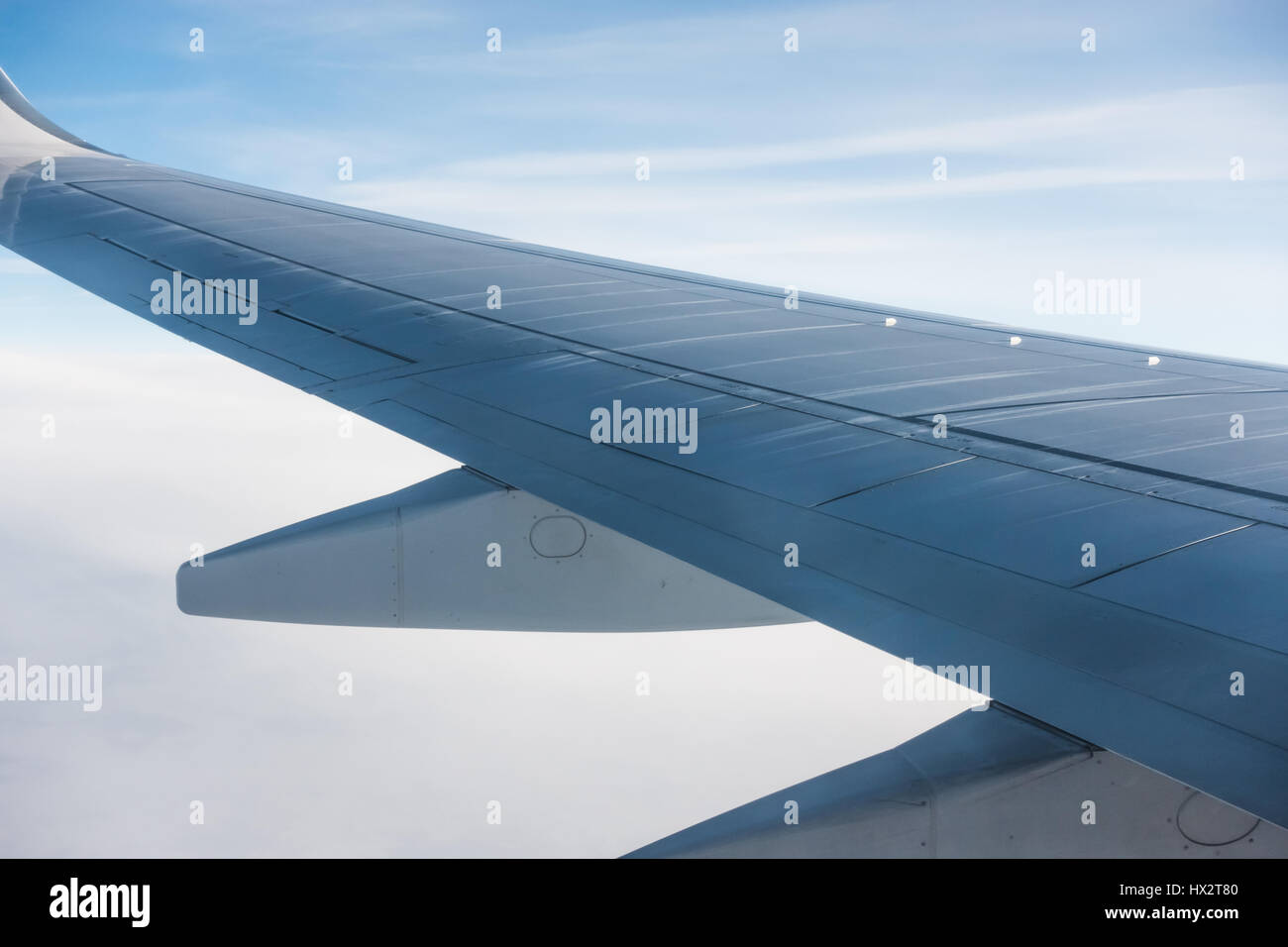 Wing of an aircraft and cloudy sky Stock Photo - Alamy