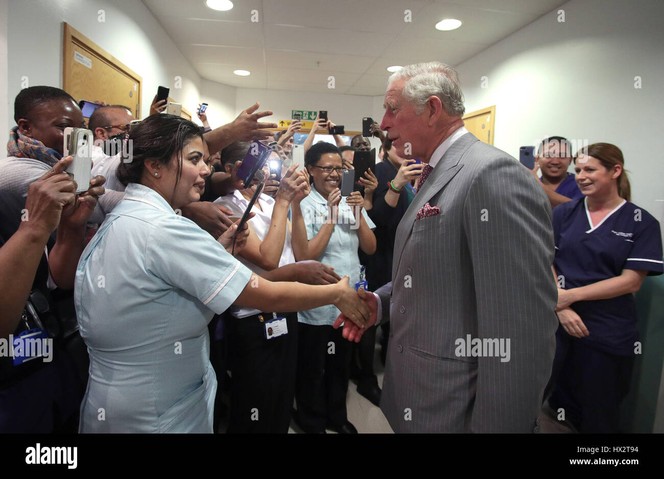 The Prince of Wales talks to nurses as he leaves after meeting ...