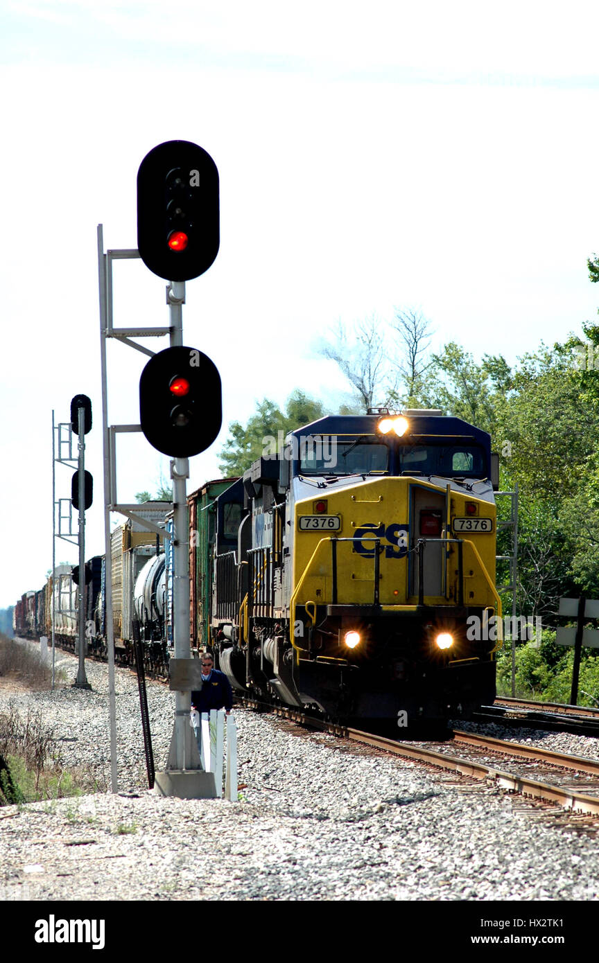 train coming down rail light on vertical Stock Photo - Alamy
