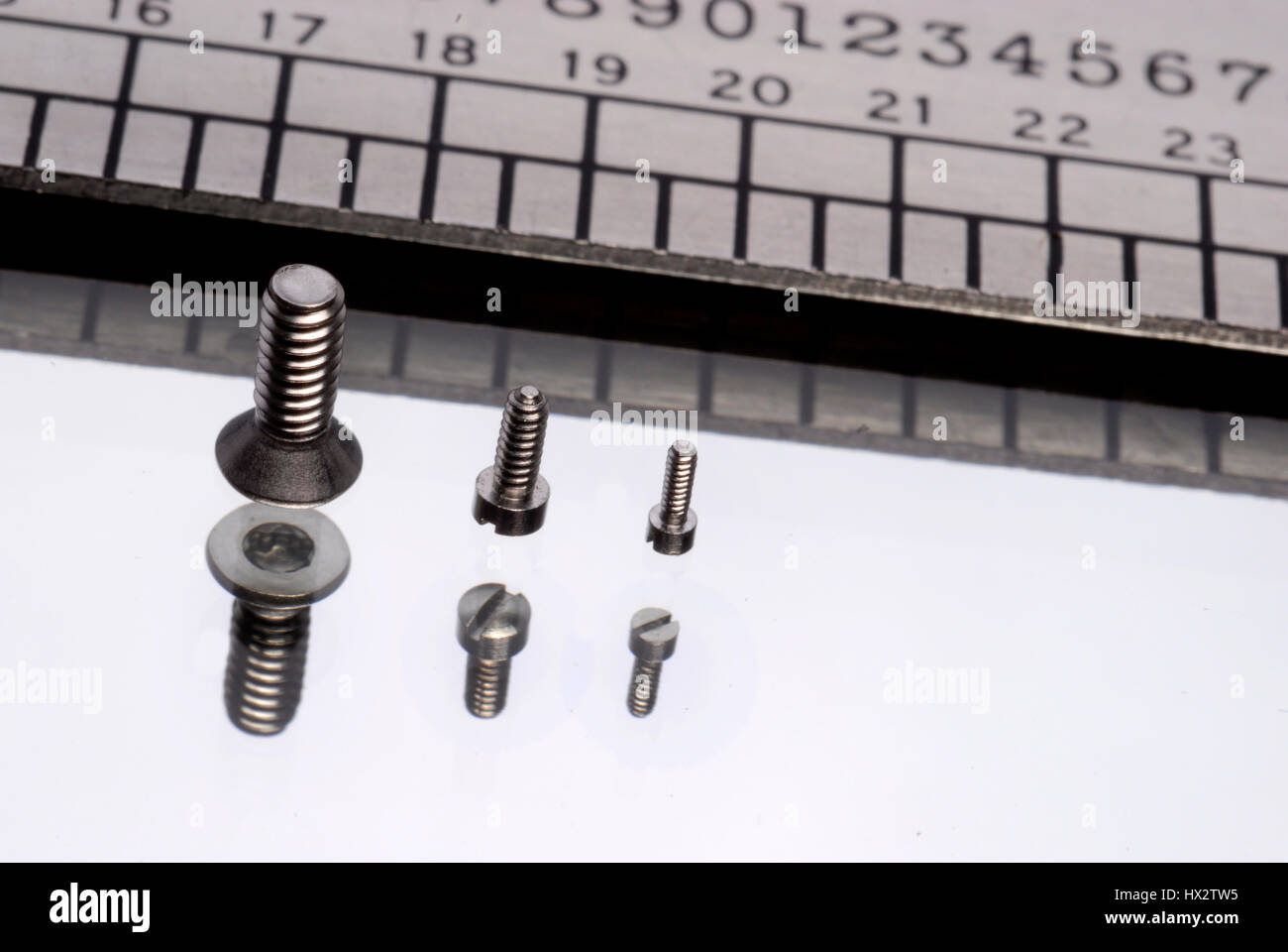 small screws with ruler on mirror Stock Photo - Alamy