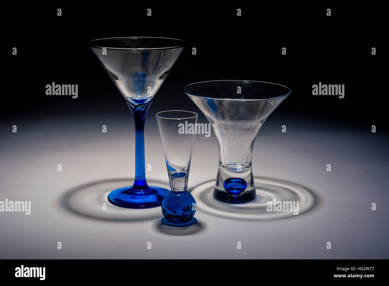 glasses with blue tint in studio Stock Photo - Alamy