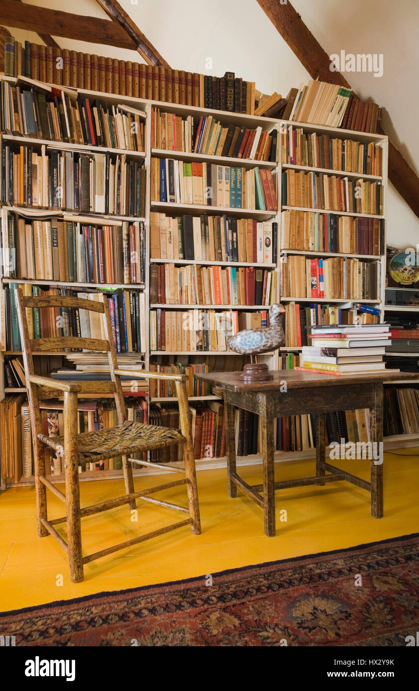 Bookcases, antique wooden chair and table in the study room of old 1810 ...