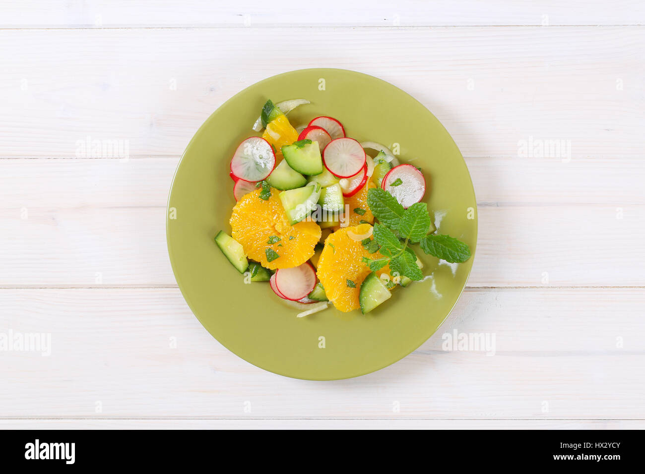 plate of radish salad with orange slices on white background Stock ...