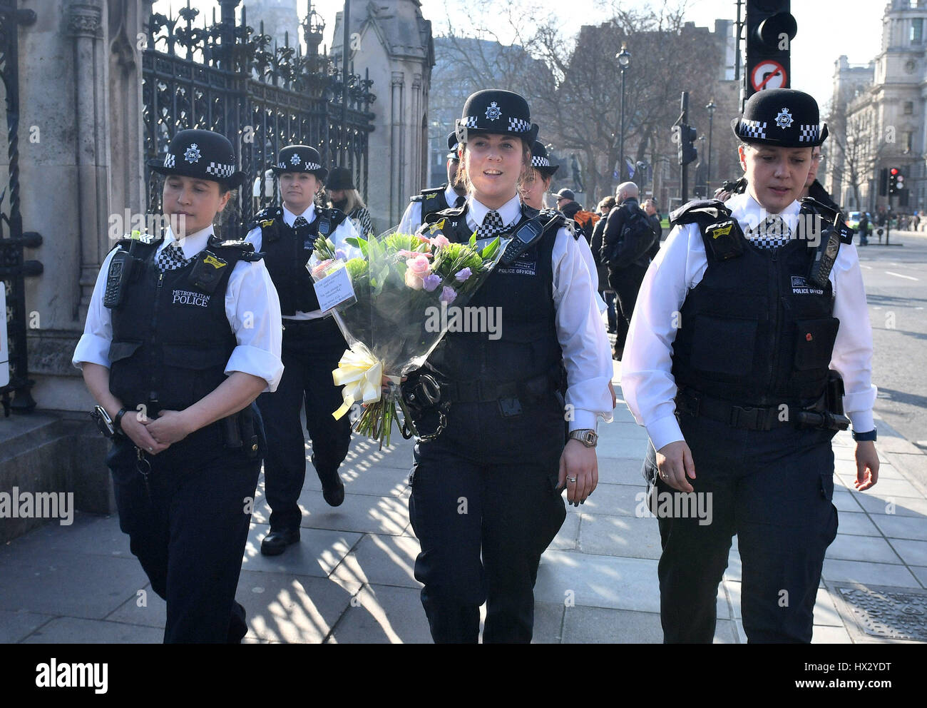 A police officer leaves flowers outside houses parliament hi-res stock ...