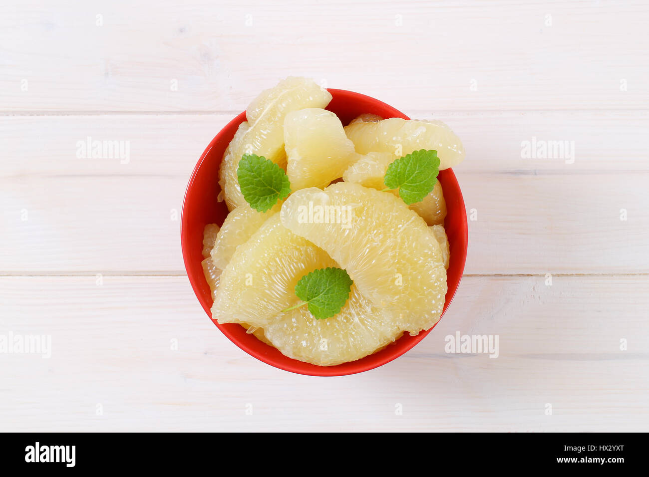 bowl of peeled and sliced pomelo on white background Stock Photo - Alamy