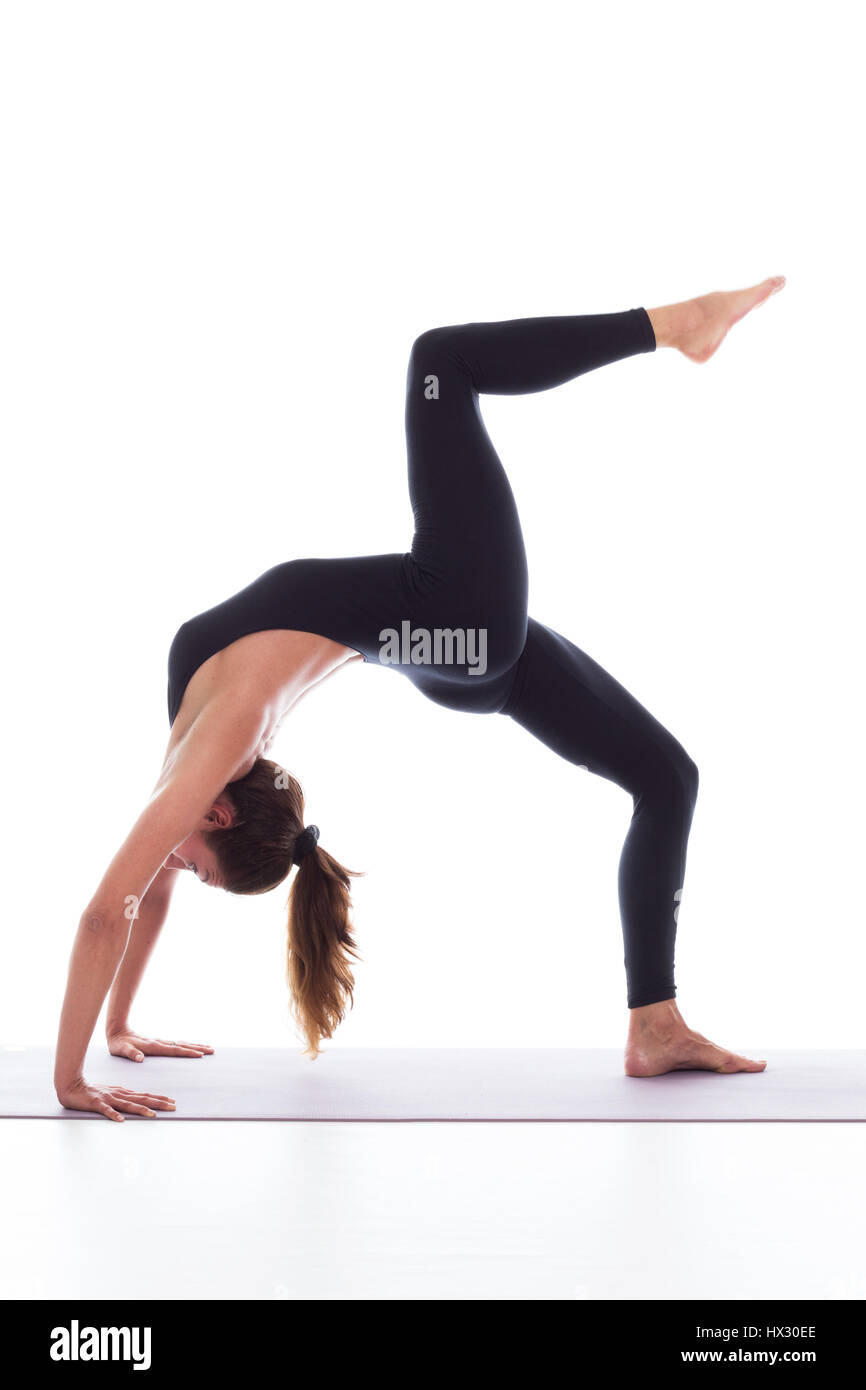 Studio shot of a young fit woman doing yoga exercises white background ...
