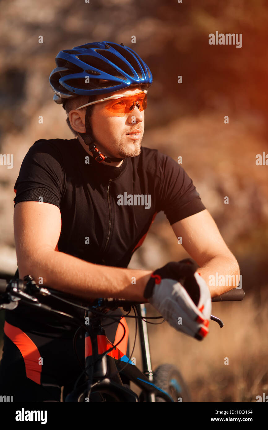 closeup portrait of professional cyclist with his bicycle in the ...