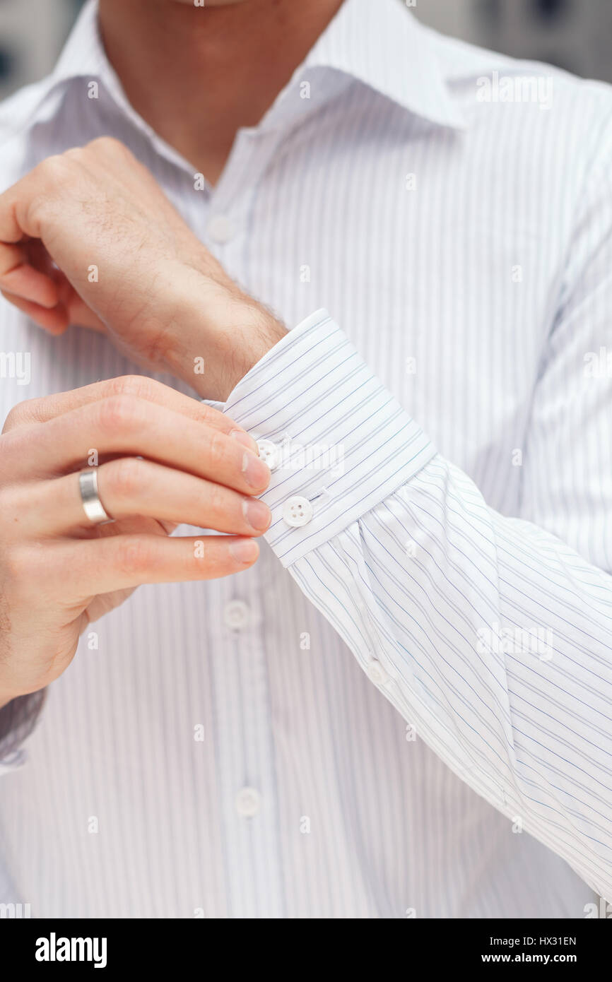 Man buttons cuff-link on French cuffs sleeves Stock Photo - Alamy