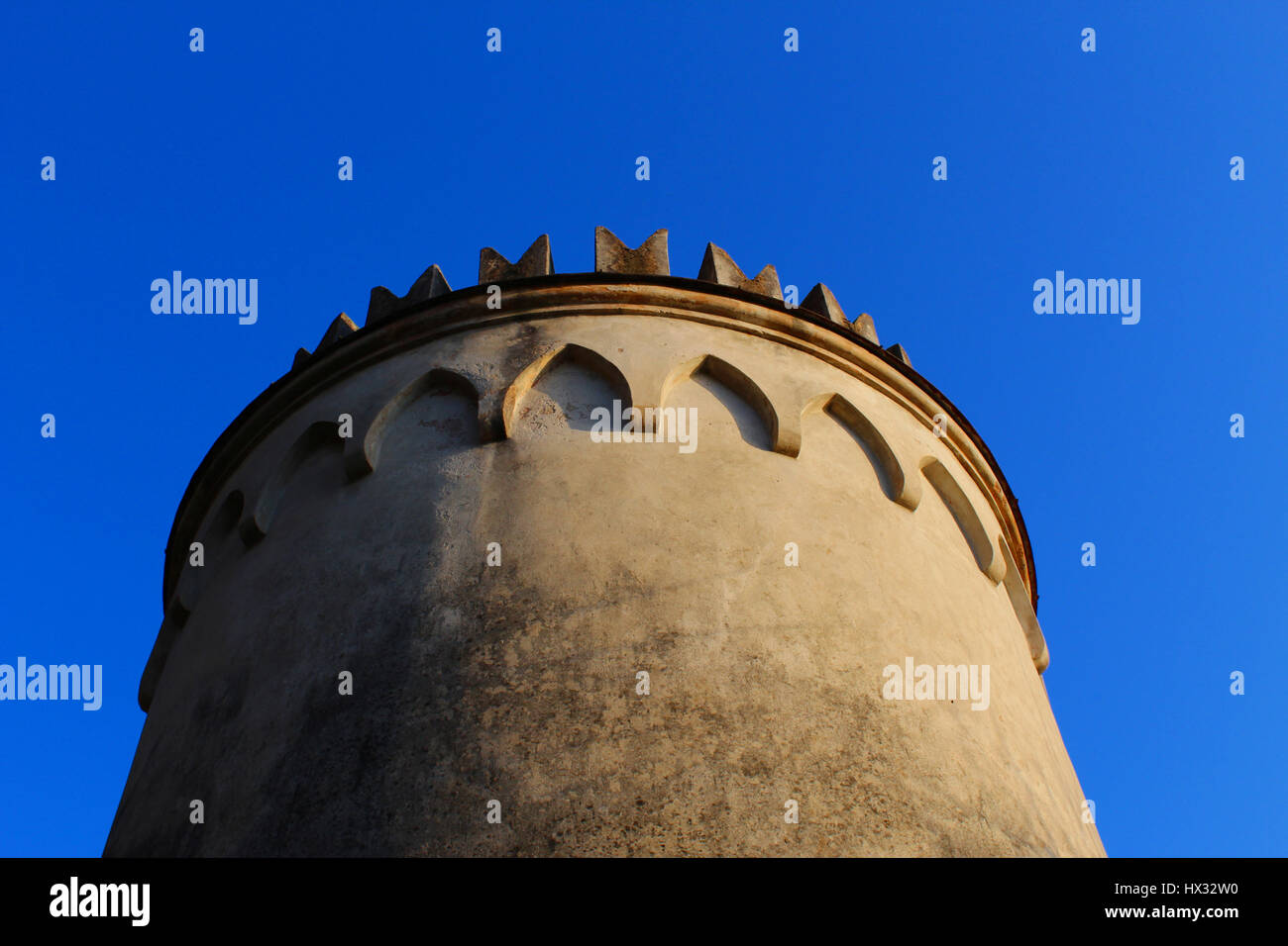 Round tower with battlements and arches Stock Photo - Alamy