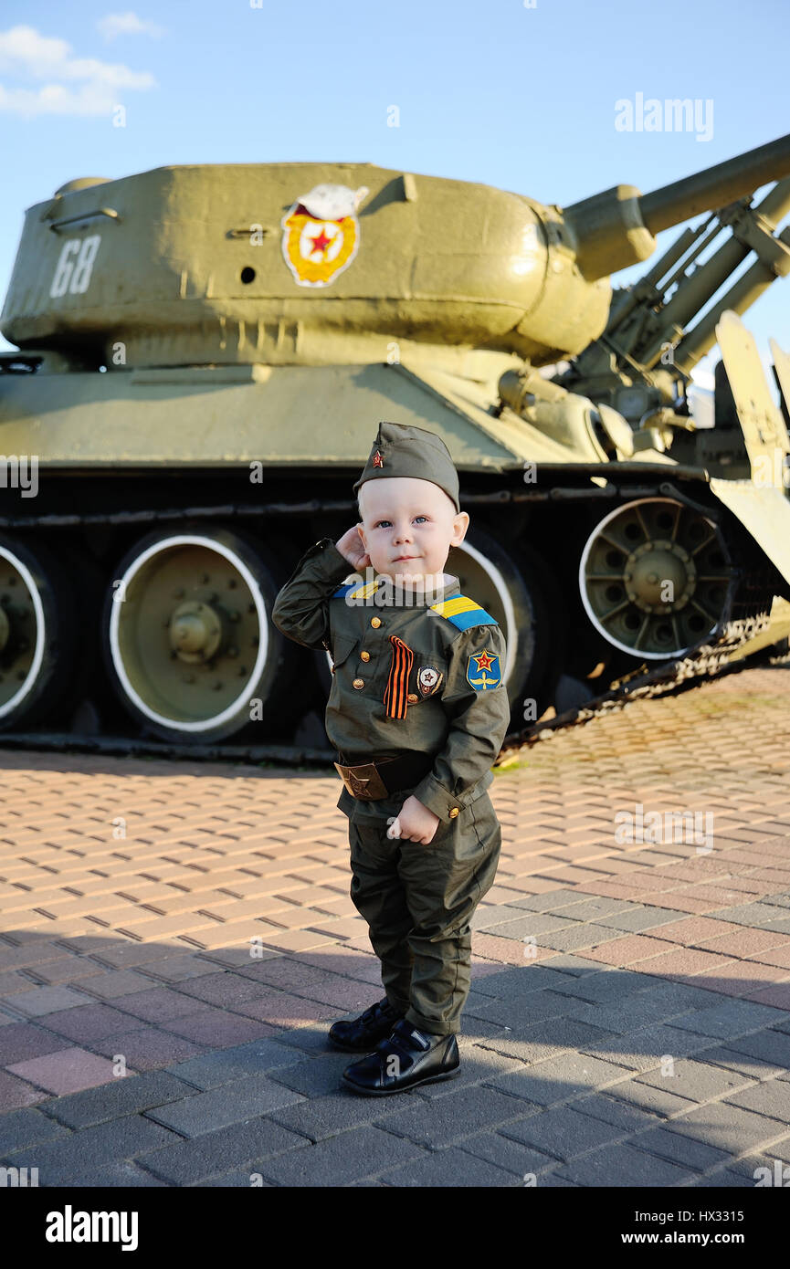 Baby boy in military uniform on tank background. May 9, World War II ...