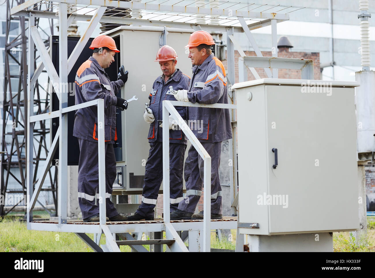 Repair team of electricians repair electrical equipment. Power station ...