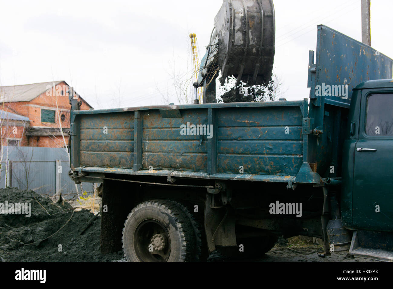 An old Soviet tractor digs and loads waste stone processing near the ...