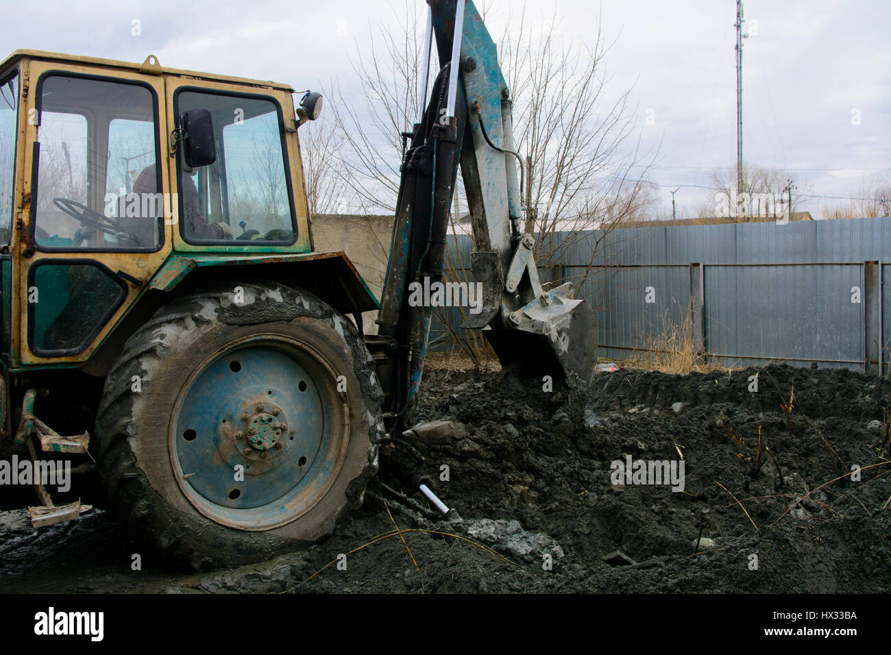 An old Soviet tractor digs and loads waste stone processing near the ...