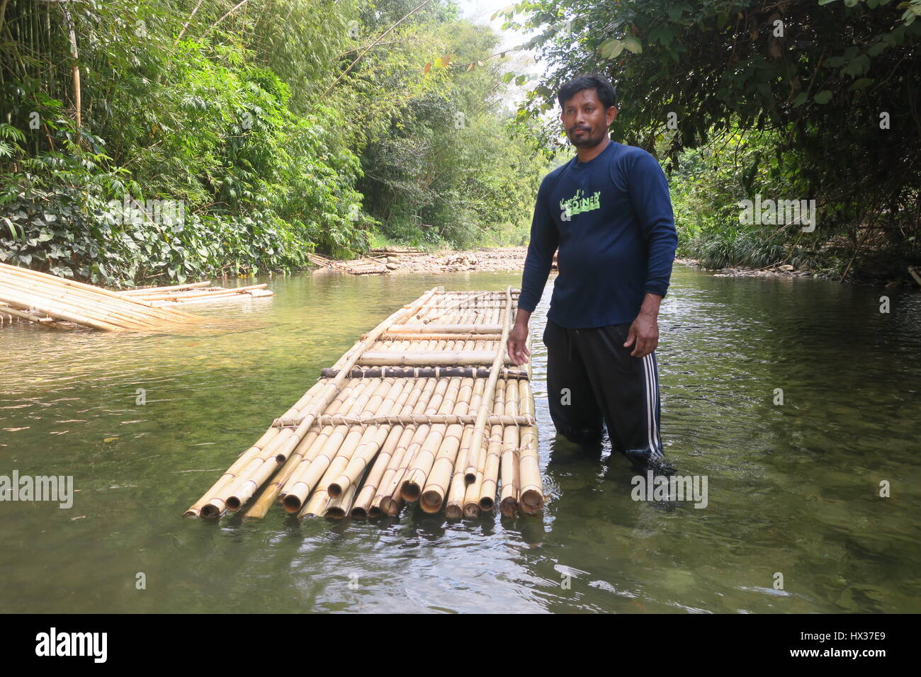 A rafter, standing in a stream is waiting tourists to come on his ...