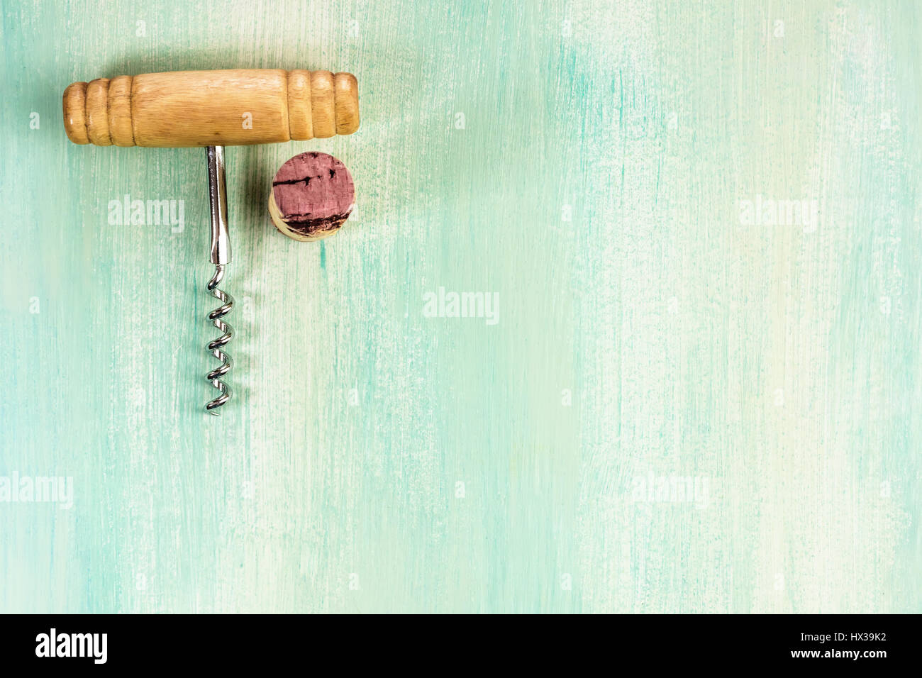 A photo of an old-fashioned corkscrew with a cork, shot from above on a ...