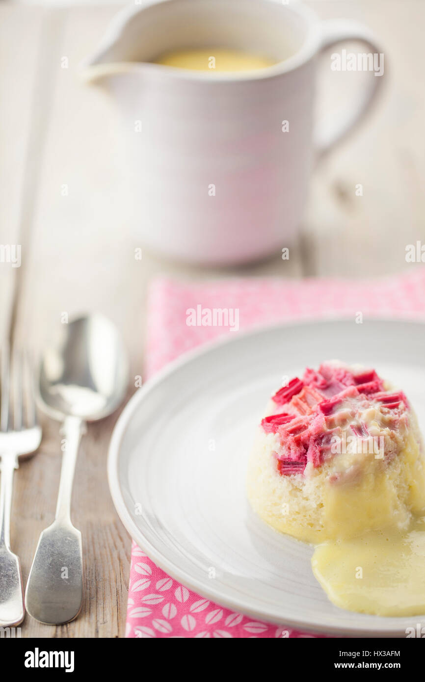 Rhubarb Sponge Pudding on Plate with Jug of Custard Stock Photo - Alamy