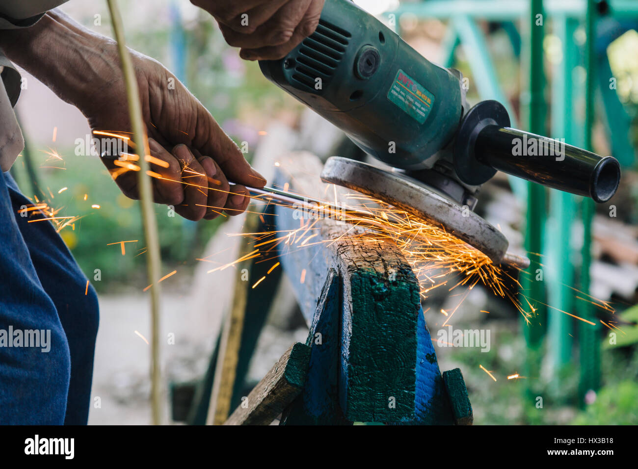 Close-up of workman working with iron Stock Photo - Alamy