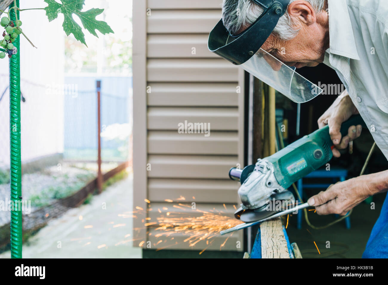 Close-up of workman working with iron Stock Photo - Alamy