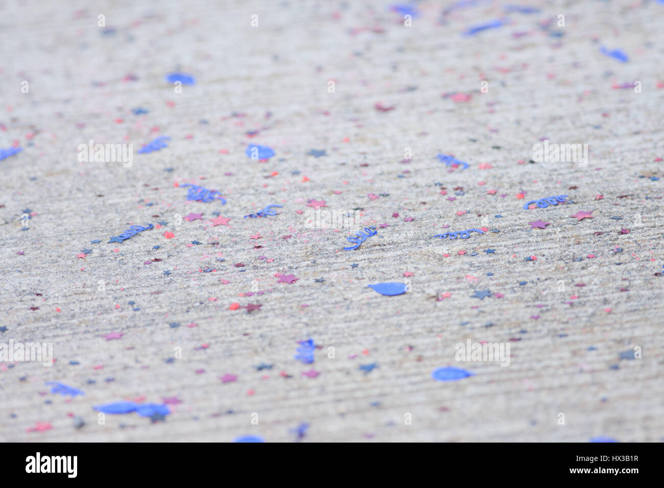Colorful blue, pink and purple confetti stars and squiggles on a clean ...