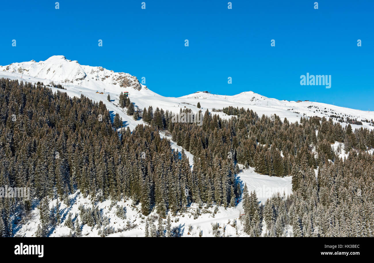 Panoramic view down snow covered valley in alpine mountain range with ...