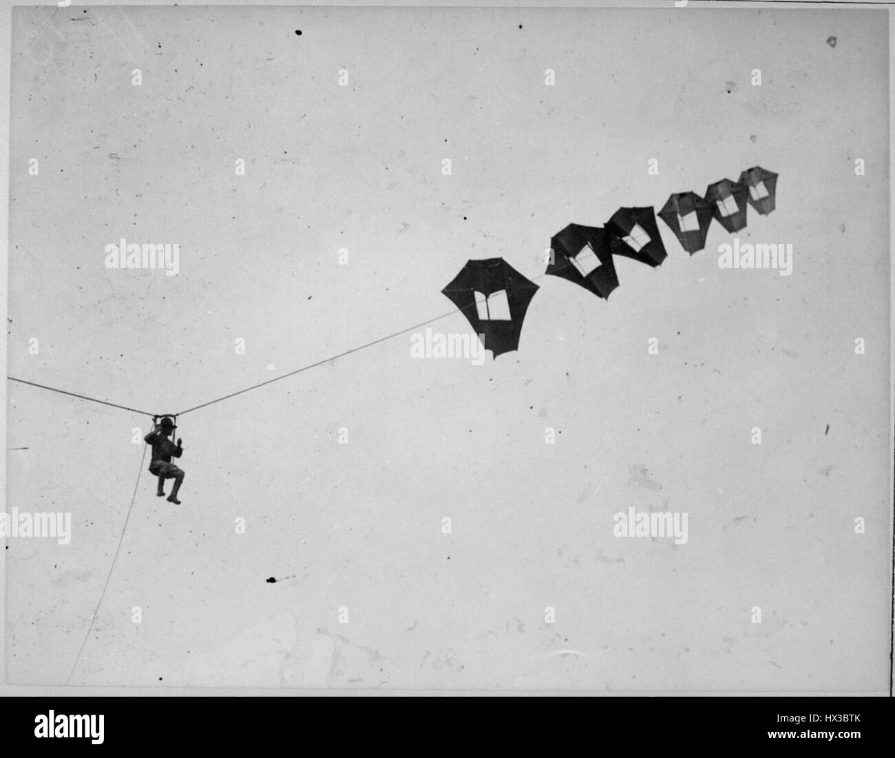 Lieutenant Kirk Booth of the US Signal Corps is lifted into the sky by ...