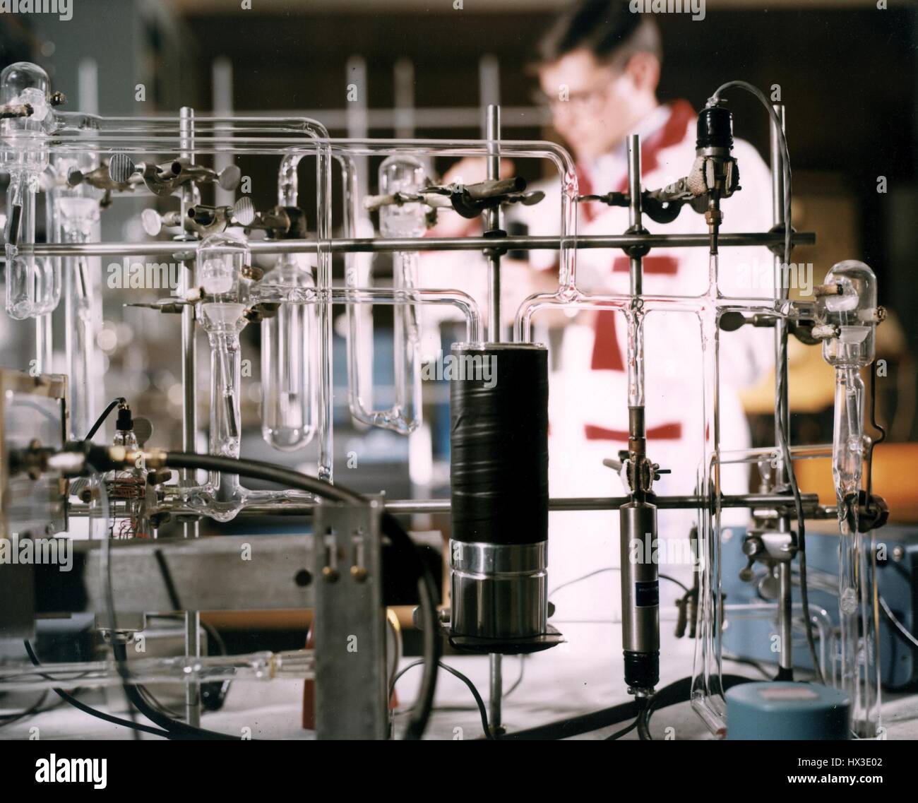 A researcher mixes coolant for addition to cold trap in a glass vacuum ...