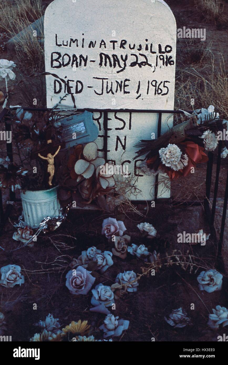 Gravestone decorated with flowers in a Spanish cemetery in Bernalillo ...