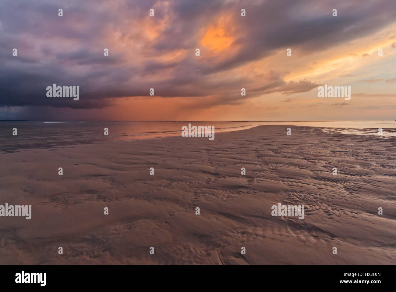 Tropical beach in ebb time on sunset background Stock Photo - Alamy