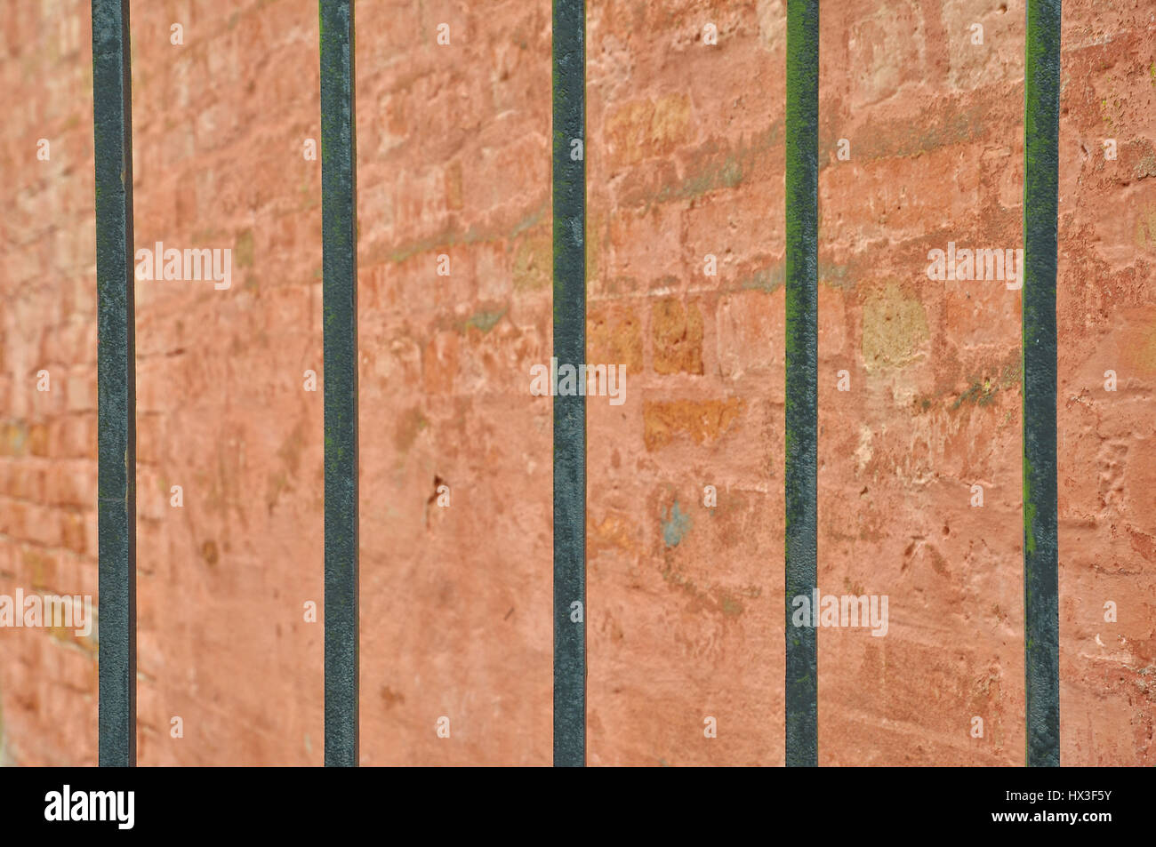 Closeup of old iron bars with ancient brick wall in the background ...