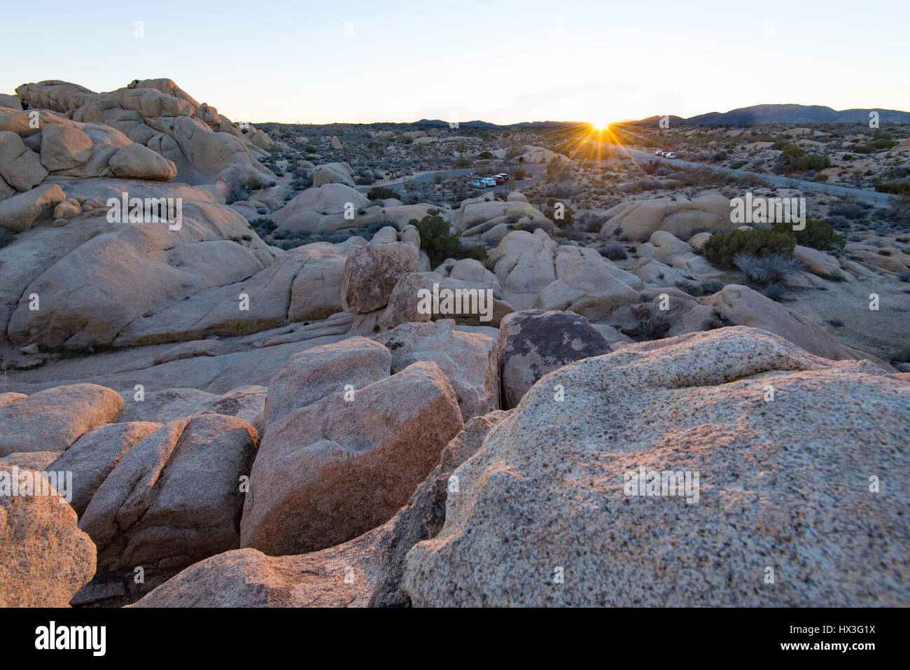 Sunset over the rounded granite rocks and boulders of Joshua Tree ...