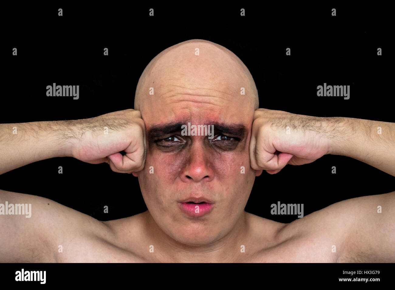 Man with makeup on his eyes. Pain feeling Stock Photo - Alamy