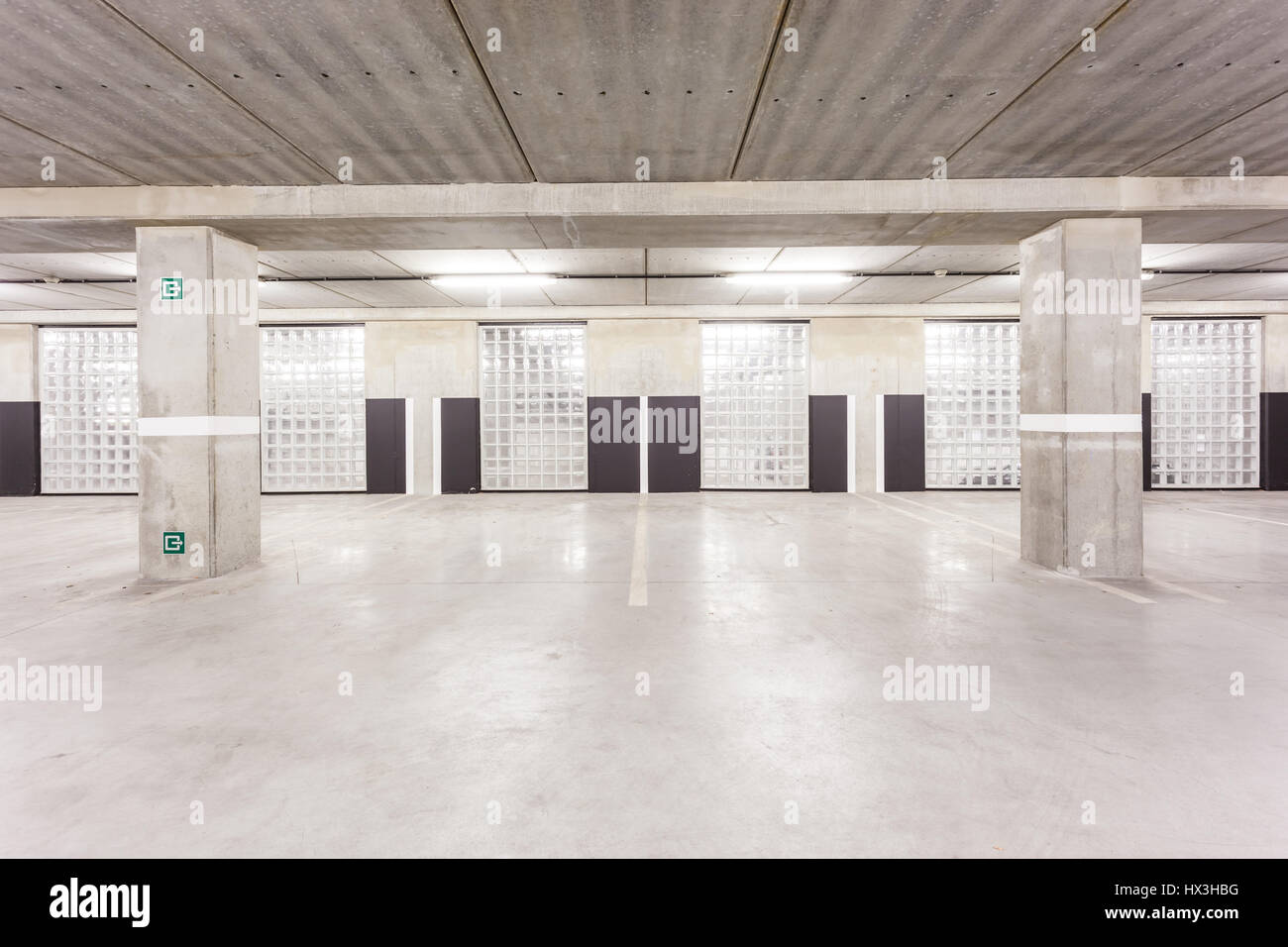 Underground park of a mall with columns and ventilation ducts Stock ...