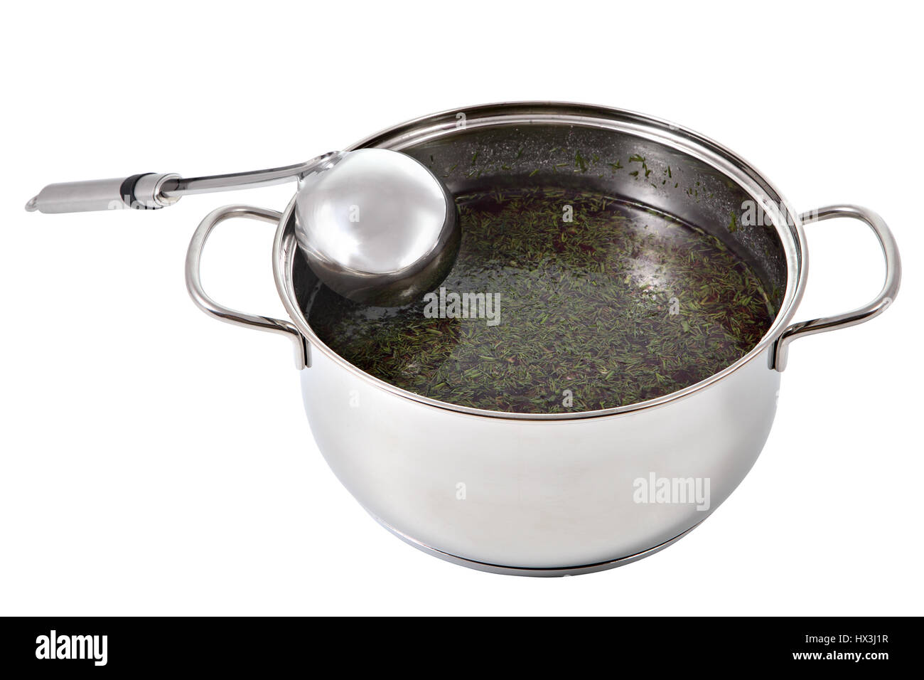 Soup ladle stainless steel lies in a pot of broth, isolated on white ...