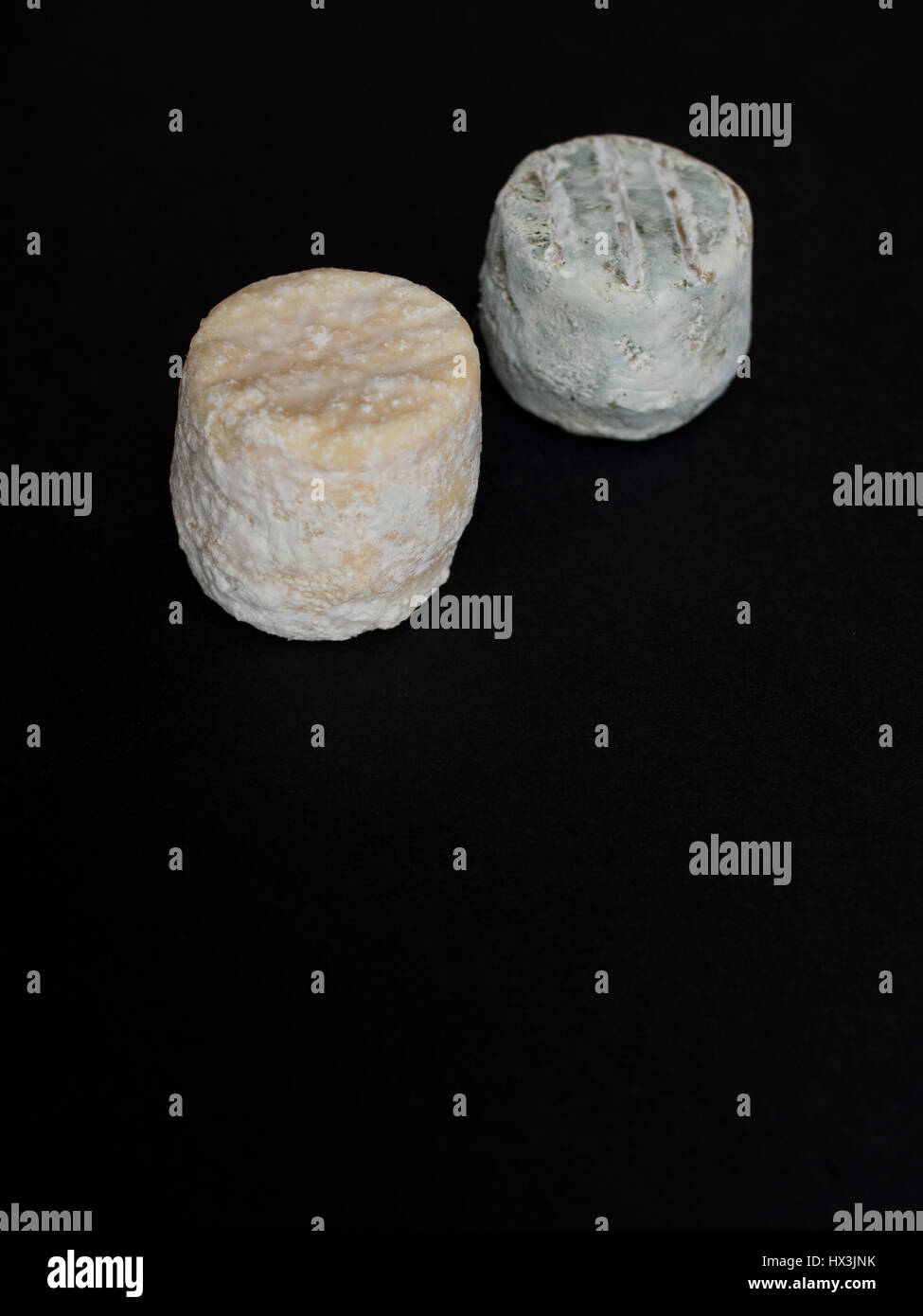 Small, dry, cylinder formed cheese isolated on black background Stock ...