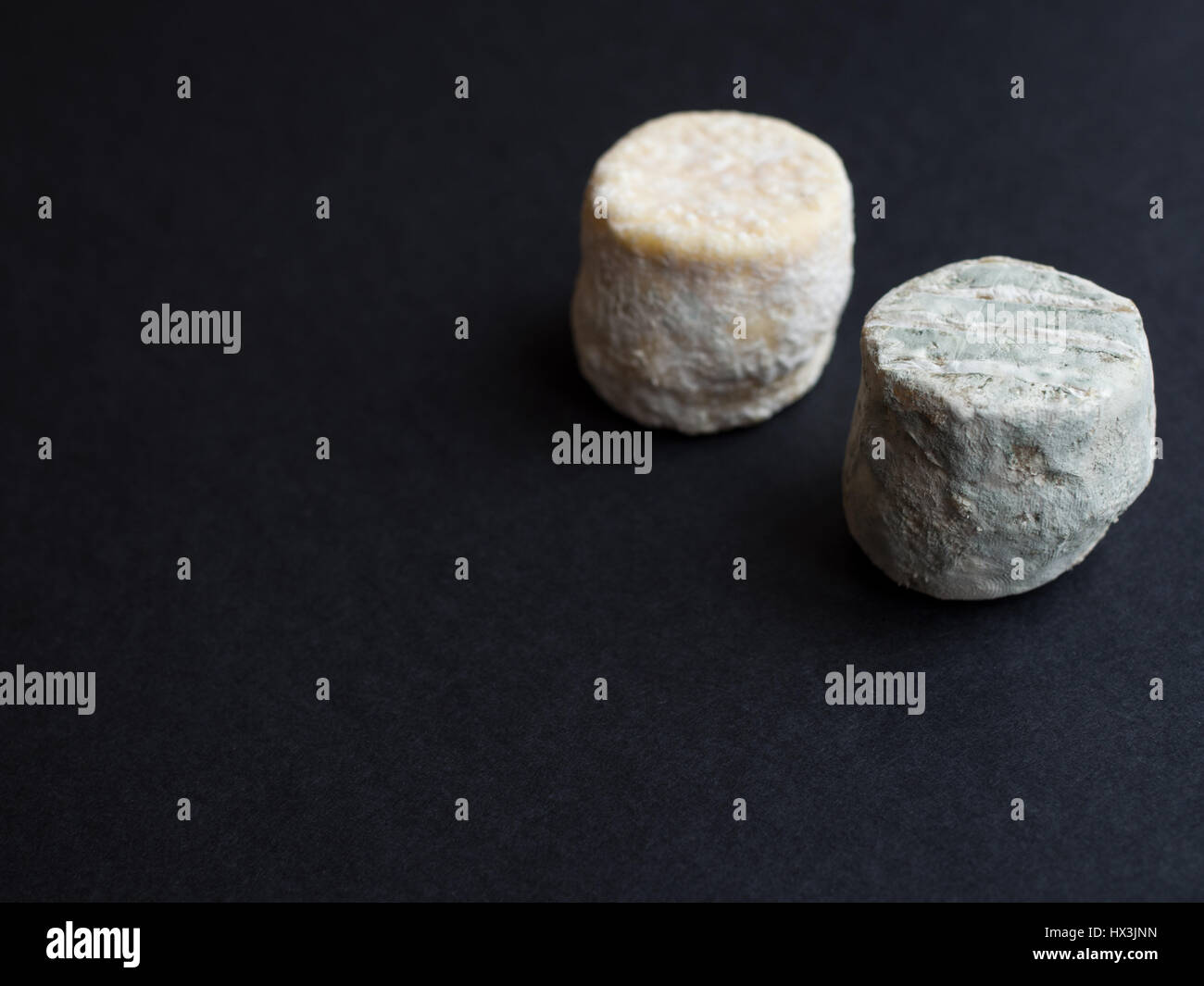 Small, dry, cylinder formed cheese isolated on black background Stock ...