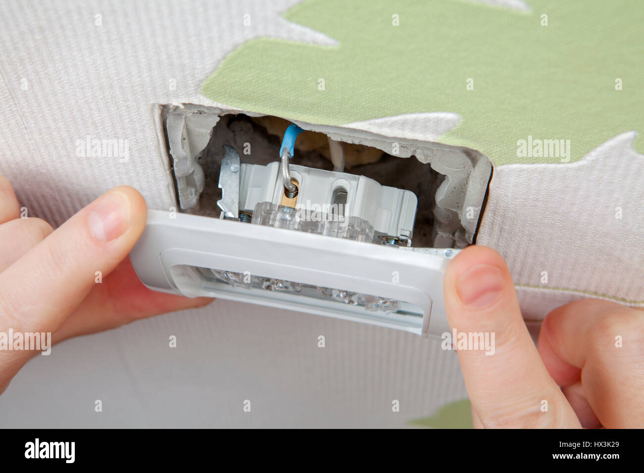 Mounting wall light switch inside the wall, close-up Stock Photo - Alamy