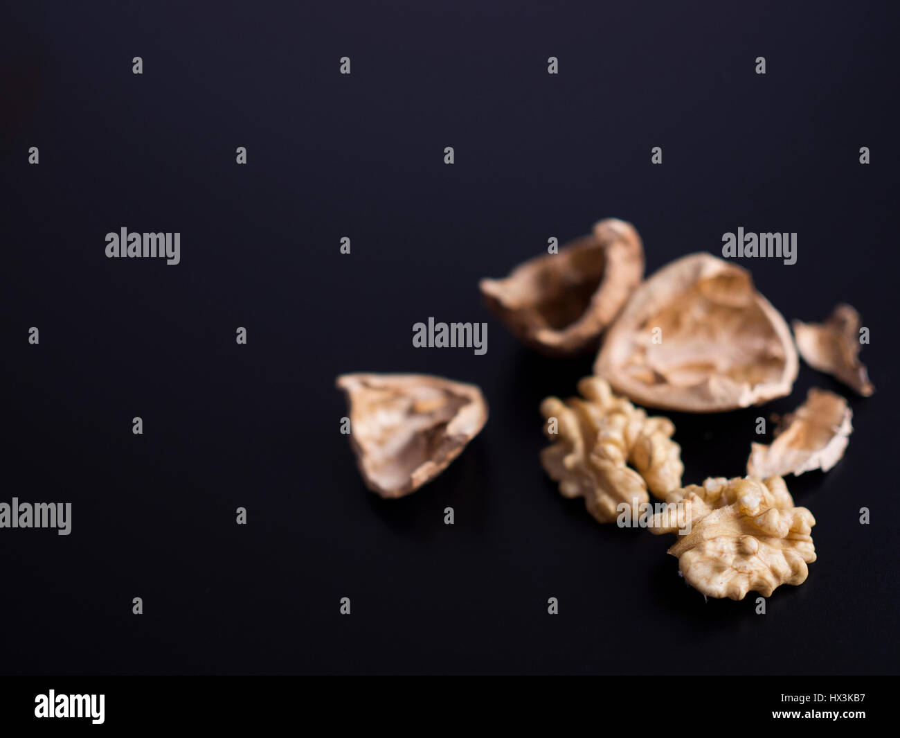 Walnut shell and kernel isolated on black background Stock Photo - Alamy