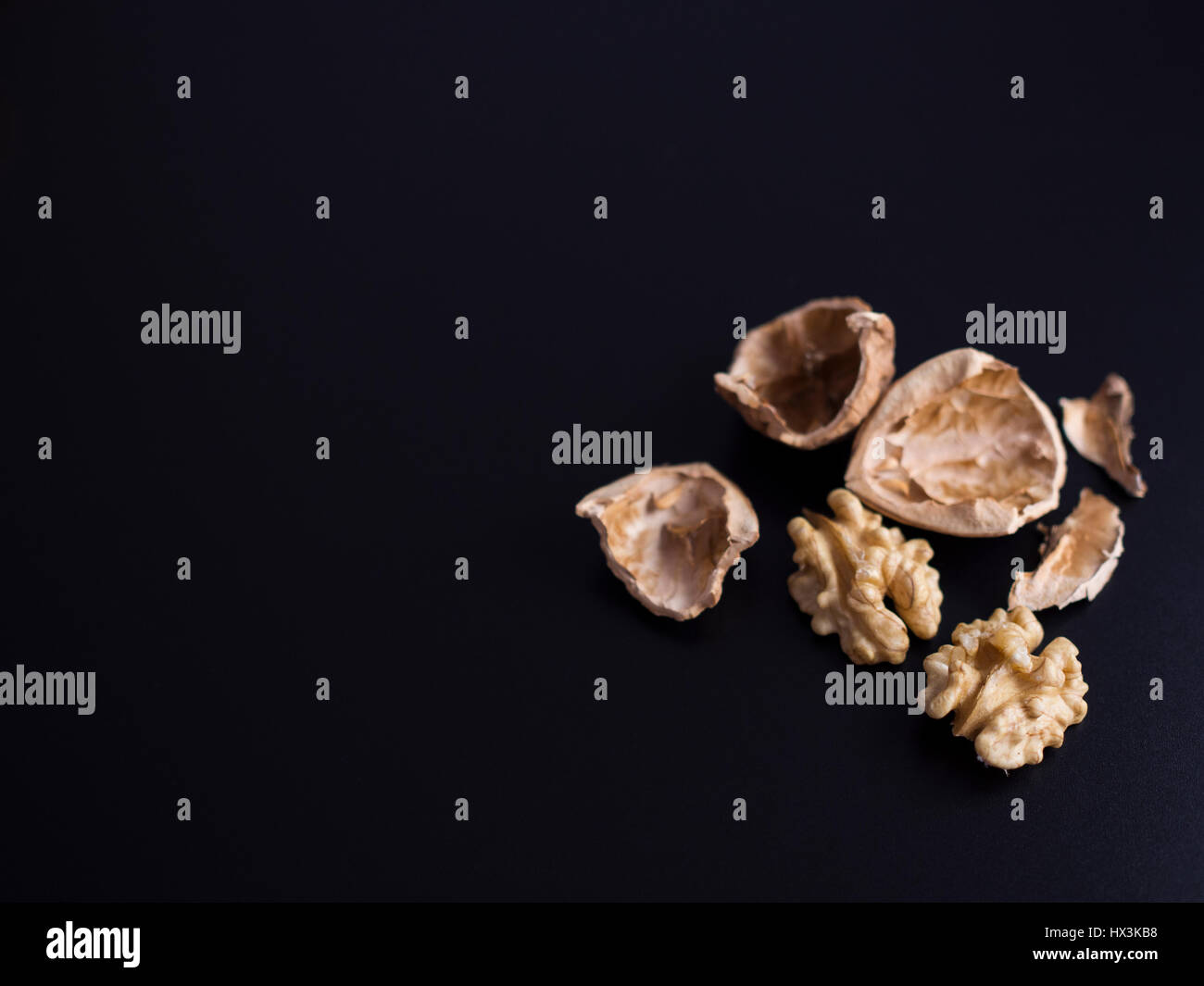 Walnut shell and kernel isolated on black background Stock Photo - Alamy