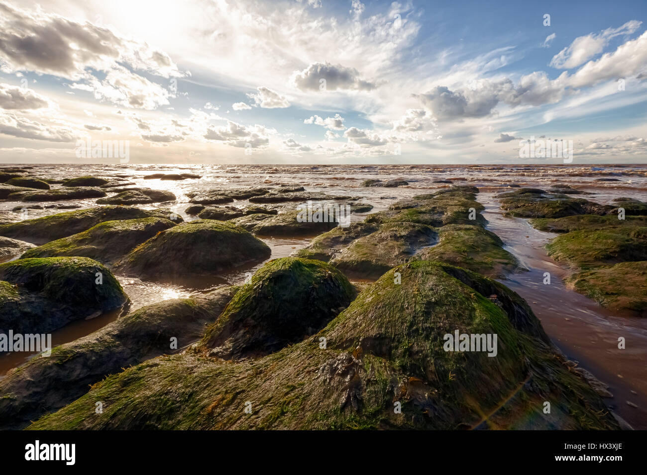 Norfolk UK rugged coastline with stunning clouds and rocks at sunset ...