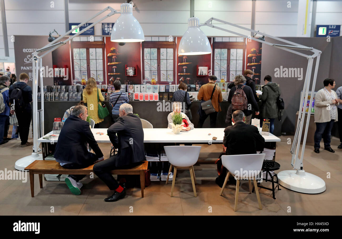 Visitors look at books at the stand of Benevento at the Leipzig Book ...