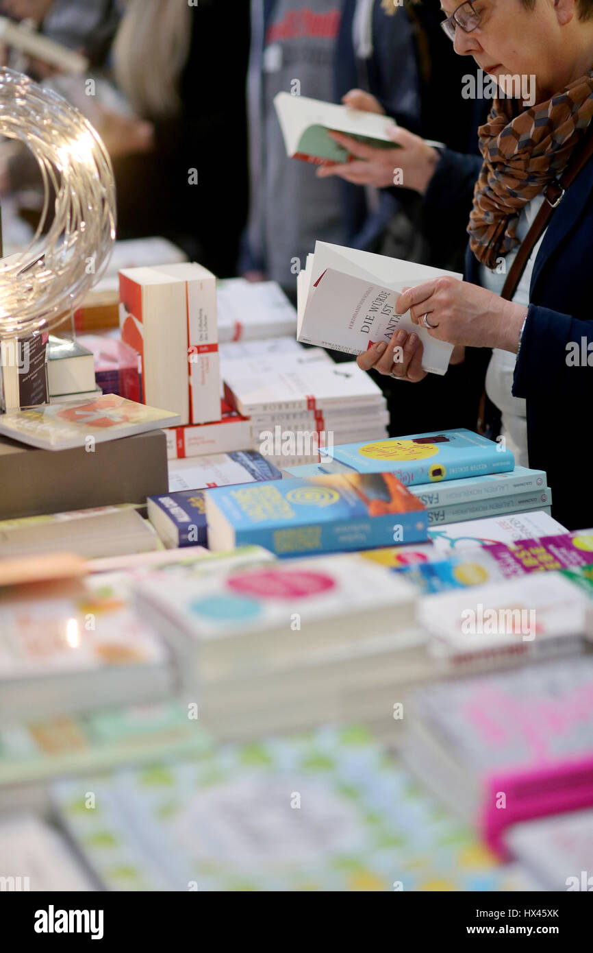Visitors look at books at the stand of Random House at the Leipzig Book ...
