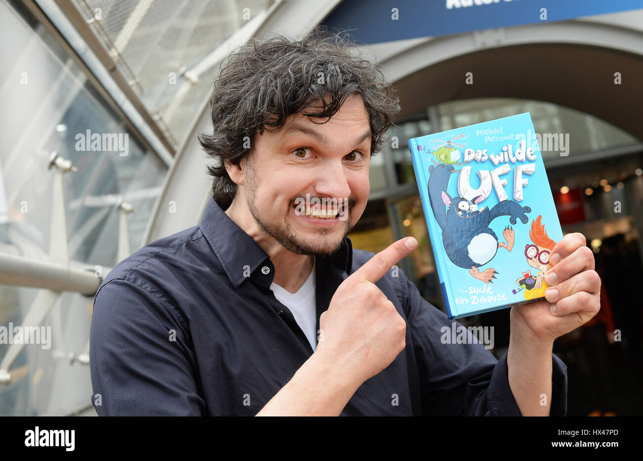 Leipzig, Germany. 23rd Mar, 2017. Writer Michael Petrowitz holds up his ...