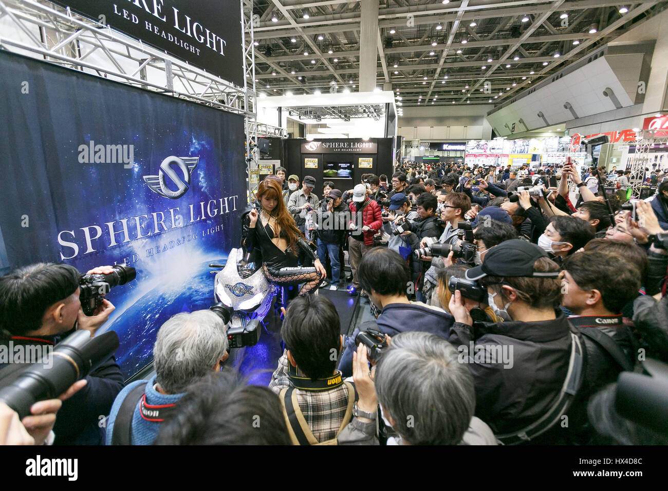 Booth assistants pose for cameras during the 44th Tokyo Motorcycle Show ...