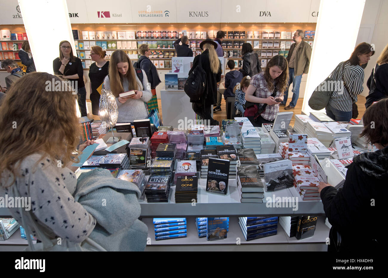 Visitors of the Leipzig Book Fair look at the stand of Random House ...