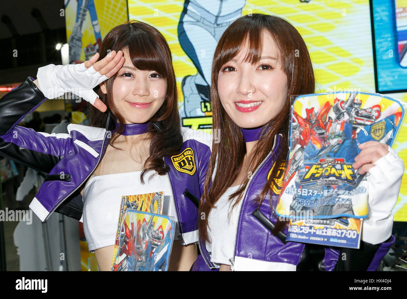 Tokyo, Japan. 25th March, 2017. Booth assistants pose for a photograph ...