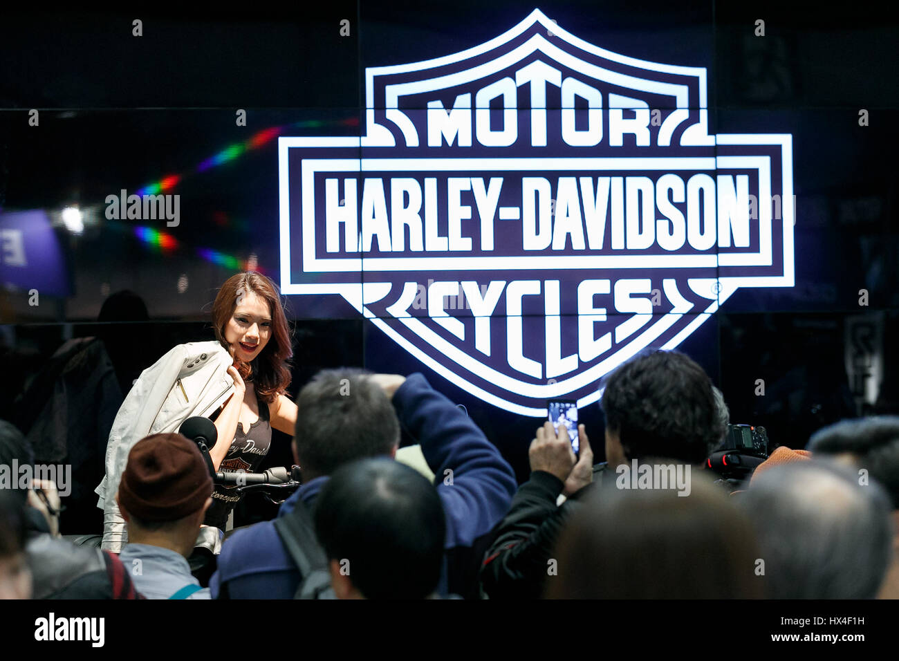 A booth assistant poses for cameras during the 44th Tokyo Motorcycle ...