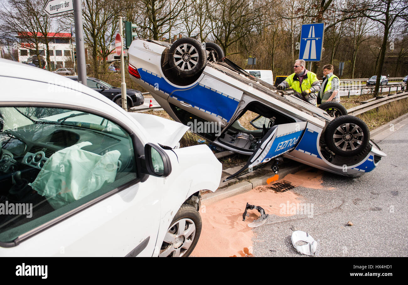 Hamburg, Germany. 21st Mar, 2017. A police car lies overturned after an ...