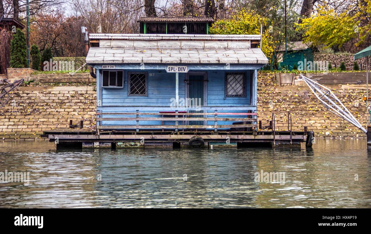 Sava River, Serbia - A blue raft house moored to the shoreline of Ada ...